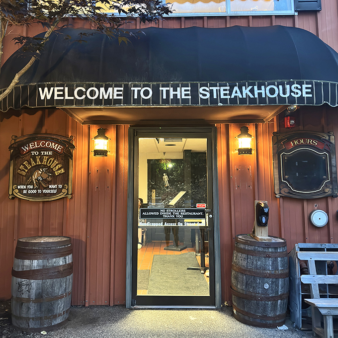 Wooden barrels flank the welcoming entrance to The Steakhouse, where the green awning invites hungry visitors to step inside for a meaty adventure.