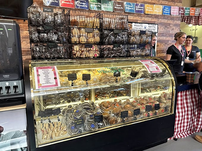 Stacked high and perfectly arranged, these whoopie pies wait patiently in their display case. The wooden backdrop adds rustic charm to this sweet treasure trove.