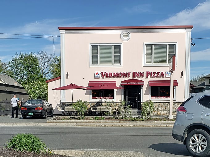 The charming exterior of Vermont Inn Pizza stands ready to serve hungry visitors, with outdoor seating perfect for sunny Vermont days.