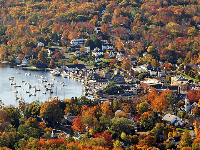 Fall foliage frames York's historic center, where colorful buildings cluster around the iconic white church like children gathered for a story.