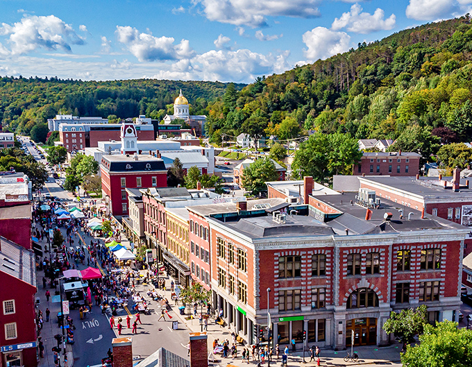 From above, Montpelier reveals its perfect balance: bustling downtown streets, the iconic gold-domed State House, and nature's green embrace.