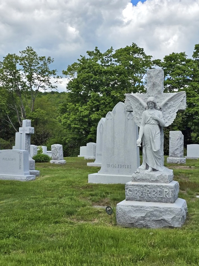 Guardian in stone, this angel stands eternal watch over the departed, wings unfurled against Vermont's verdant backdrop.