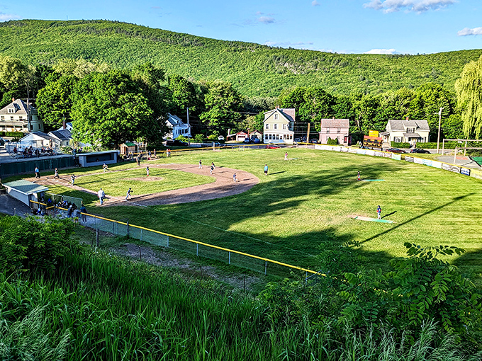 Little League diamonds nestled in mountain valleys prove that even baseball looks better when surrounded by peaks that touch the clouds and make outfield flies seem almost poetic.