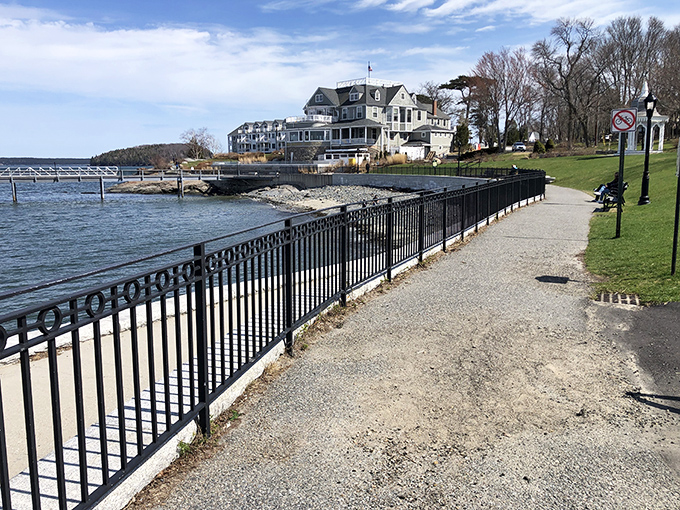 The well-maintained pathway invites strollers to wander between the rocky Maine shoreline and manicured lawns of historic properties.