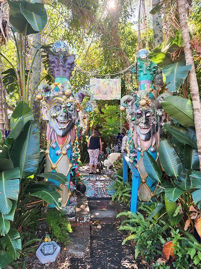 Carnival-inspired sentinels guard the entrance to a tropical wonderland, their exaggerated grins inviting brave souls to venture deeper.