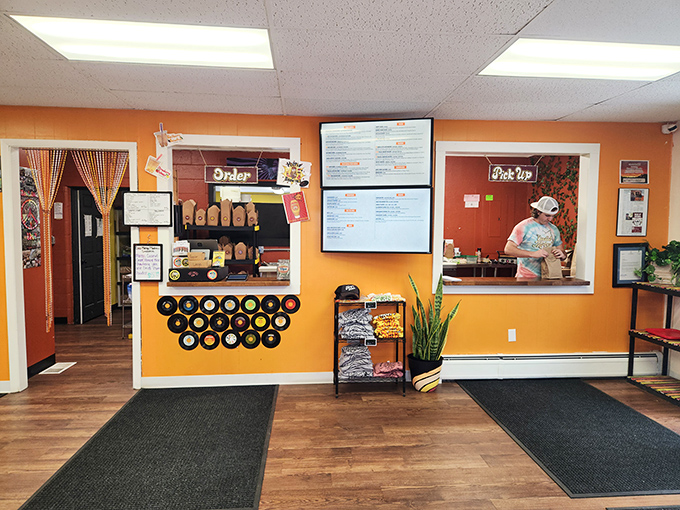 Step inside to a warm orange interior where vintage vinyl records line the walls and the ordering counter beckons with promises of creative culinary adventures.