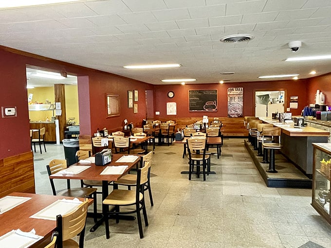 Inside, burgundy walls and wooden wainscoting create that perfect diner atmosphere where conversations flow as freely as the coffee.