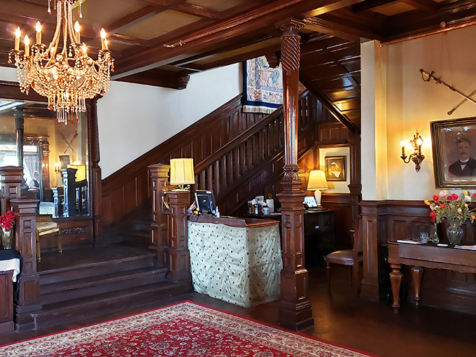The grand entrance hall welcomes guests with gleaming woodwork, crystal chandeliers, and an atmosphere of Victorian elegance that whispers tales of bygone eras.