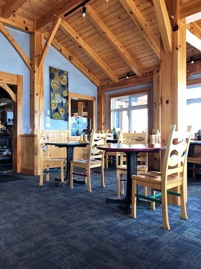 Timber-framed ceilings soar above light-washed dining spaces, where every wooden beam tells a story of North Shore craftsmanship and lakeside charm.