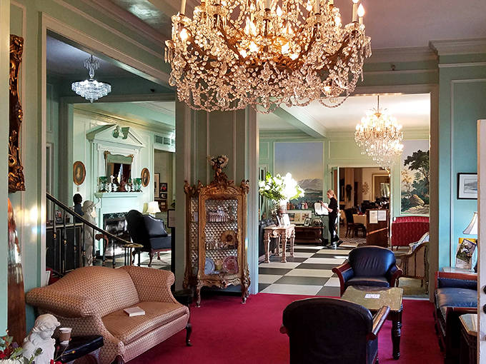 Crystal chandeliers illuminate the elegant lobby, where the black-and-white checkered floor sets the stage for an experience that balances historic charm with timeless comfort.