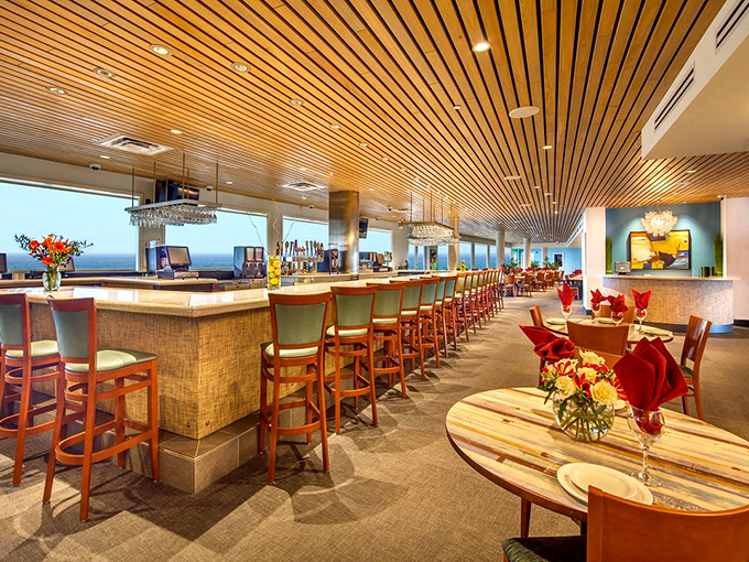 Interior: Warm wooden ceilings curve like an upturned boat hull, creating an atmosphere where elegance meets beachy comfort.