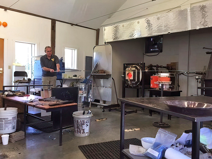 The workshop interior reveals the organized chaos of creativity &ndash; tools at the ready, furnaces glowing, possibilities endless.