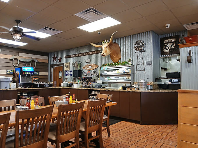 Interior: Longhorn meets comfort food heaven &ndash; that watchful steer presides over a dining room where country charm isn't manufactured, it's marinated over decades.