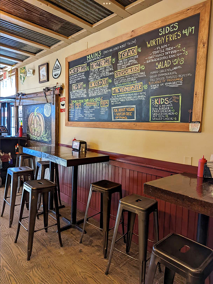 Inside, the rustic interior features wooden walls, chalkboard menus, and metal stools that create an atmosphere both authentically Vermont and irresistibly inviting.