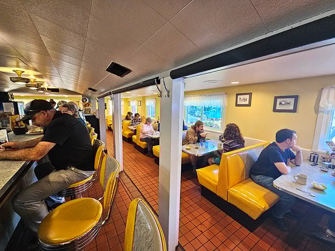 Sunshine-yellow booths cradle conversations and comfort food dreams in a space where time slows down just enough to savor every bite.