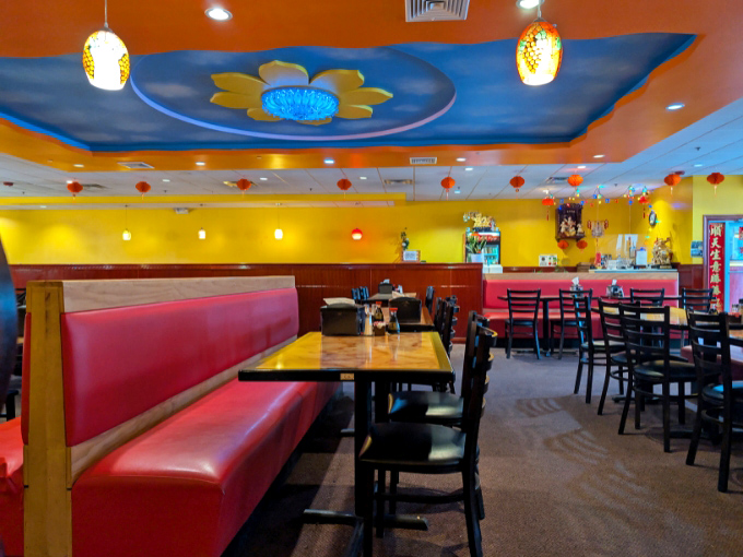 Vibrant yellow walls and a whimsical sky-painted ceiling create a cheerful atmosphere that sets the stage for culinary exploration.