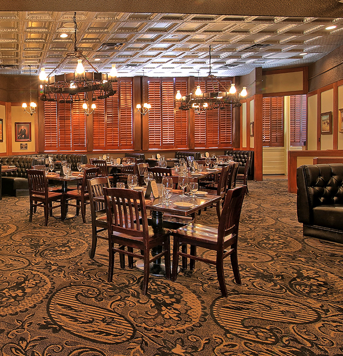 Step inside to a dining room where pressed tin ceilings and warm wood create an atmosphere that whispers "special occasion" without shouting it.