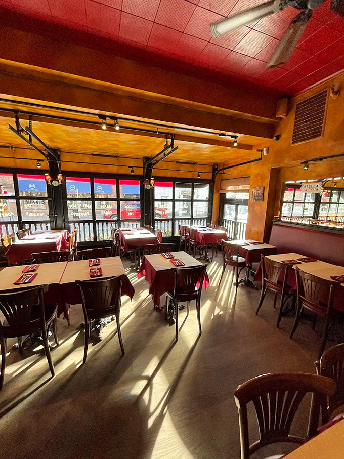 Step inside where tin ceilings meet burgundy warmth, creating the kind of atmosphere that makes you want to order wine and discuss existentialism, or at least dessert.