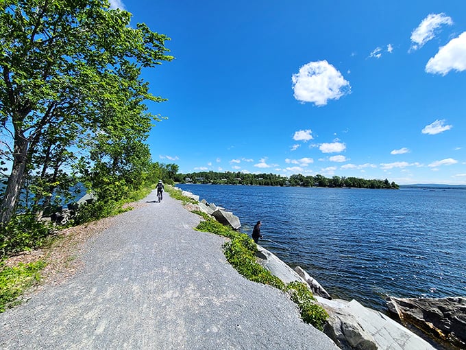 Cyclists enjoying the ultimate lake view – where else can you pedal with water lapping at both sides?