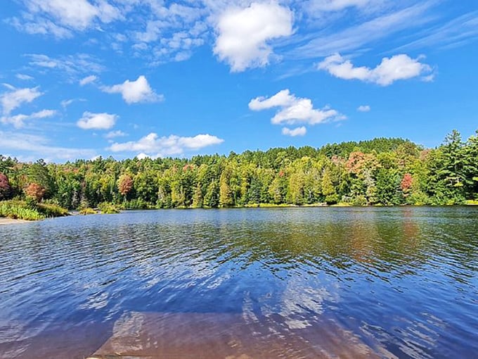 Mirror-like waters reflect a perfect Michigan sky, creating that rare moment when looking down feels like looking up.