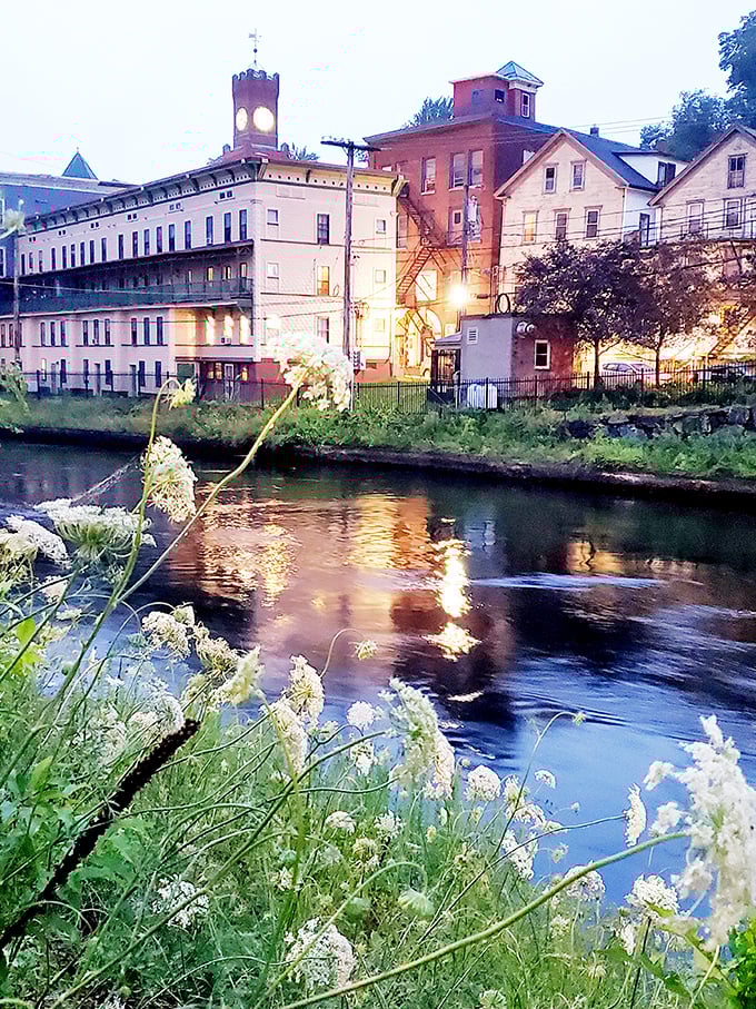Twilight transforms the Connecticut River into a mirror, doubling the beauty of historic mill buildings in a display no filter could improve.