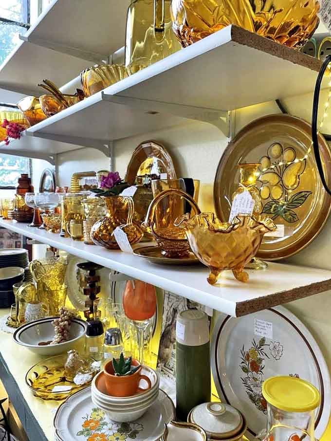 Amber glassware catches light like liquid honey, transforming ordinary shelves into a museum of domestic elegance from decades past.