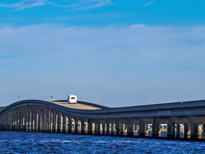 Engineering marvel meets natural beauty at this undulating bridge, where vehicles seem to float above the water.