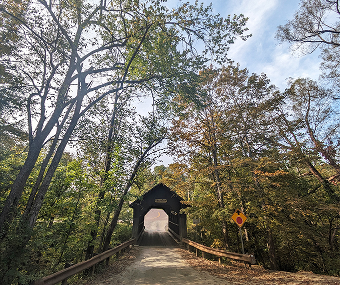 Daylight transforms the haunted crossing into a picturesque New England scene, though the legends linger beneath autumn's golden embrace.