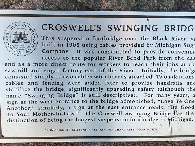 History comes alive on this weathered sign, telling tales of sugar factories, sawmills, and the ingenious Michigan folks who built this swaying marvel.