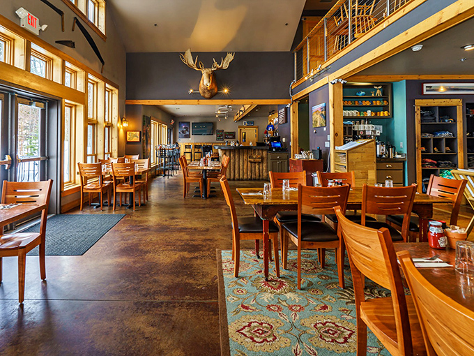 Inside, rustic elegance meets Maine woods charm with soaring ceilings, wooden beams, and that moose who seems to approve of your menu choices.