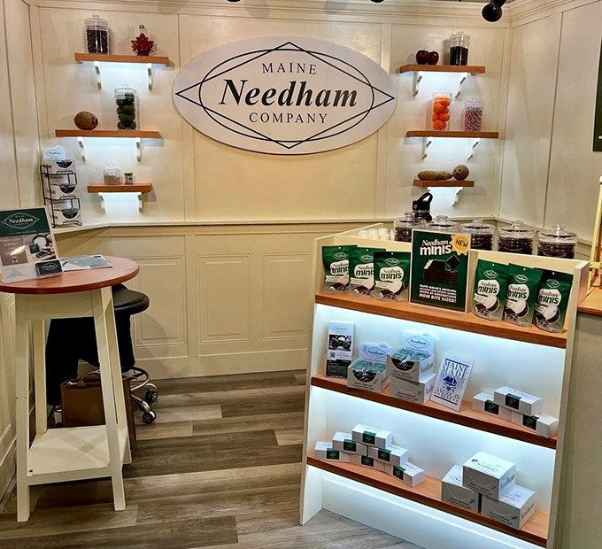 The Maine Needham Company's charming retail space welcomes candy lovers with warm wood tones and neatly arranged sweet treasures.