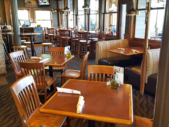 Warm wooden tables and panoramic windows bring the outdoors in, creating a dining room where nature becomes part of the decor.