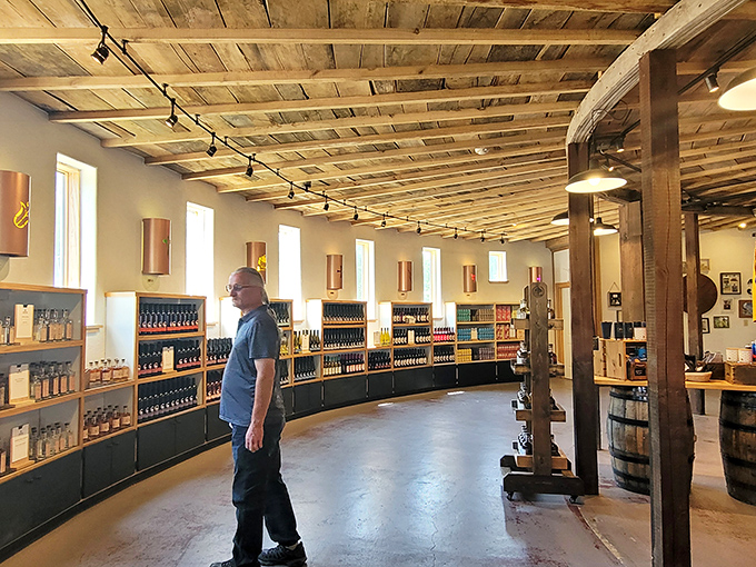 Interior splendor: Rustic wooden beams arch overhead in this cathedral to craft beverages, where sunlight streams through windows illuminating bottles of liquid Michigan magic.