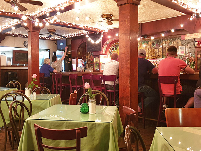 String lights twinkle above wooden booths, creating the perfect atmosphere for lingering conversations and second helpings in this basement-level gem.