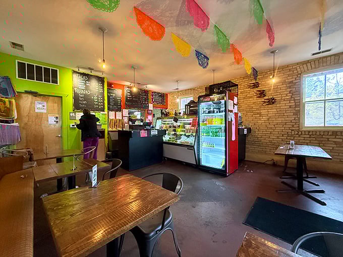 Colorful papel picado flags dance overhead while exposed brick walls create the perfect backdrop for your next food adventure.