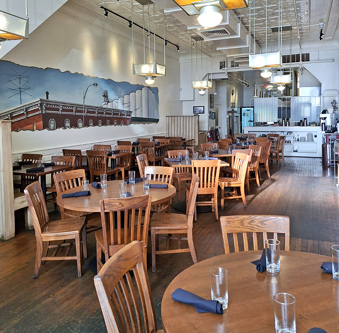 Warm wooden tables, comfortable chairs, and that gorgeous mural create the perfect backdrop for memorable meals and conversations that flow as smoothly as the service.