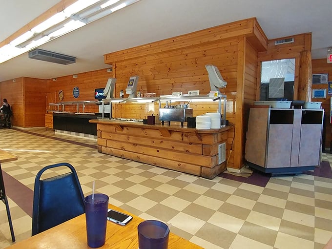 Warm wood paneling and checkered floors create a cozy, unpretentious atmosphere where the food takes center stage.