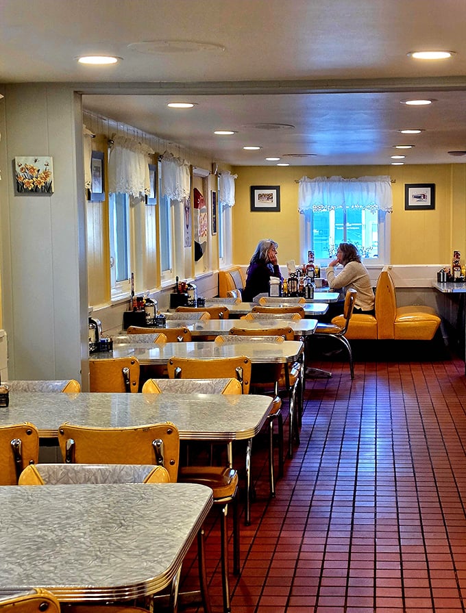 Yellow booths and chrome details create the kind of atmosphere where you half expect someone to drop a nickel in the jukebox and order a malted.