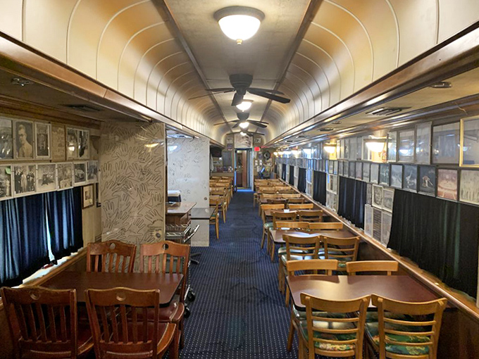 Step inside and journey down the narrow aisle where wooden tables line both sides, creating an intimate dining experience beneath the curved ceiling.