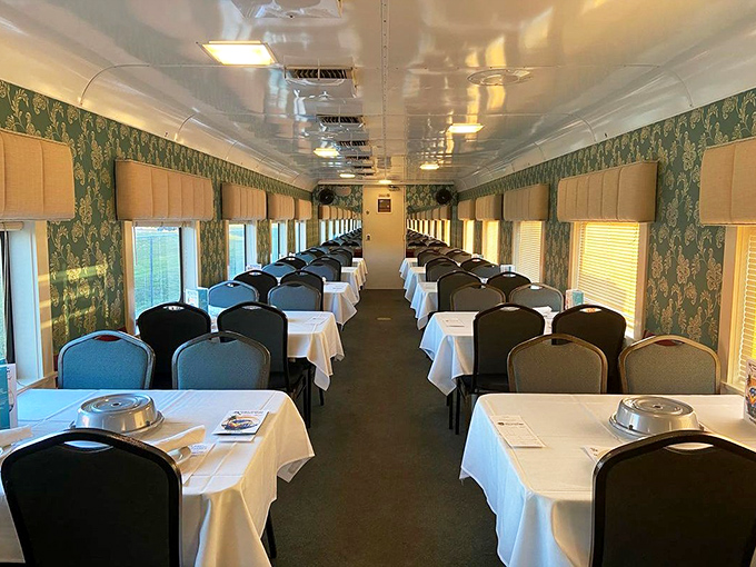 Elegant dining awaits inside the restored train car, where white tablecloths and vintage decor set the stage for both culinary delights and criminal intrigue.