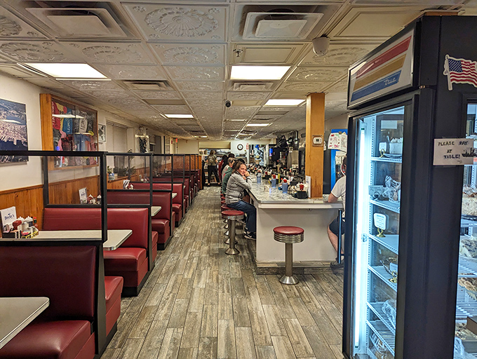 Classic diner ambiance with red vinyl booths and counter seating creates the perfect backdrop for memorable meals and conversations.