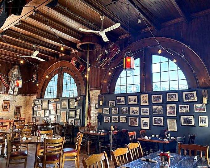 Soaring ceilings and original wooden beams create a dramatic backdrop for dining, while vintage photos tell stories of the building's heroic past.