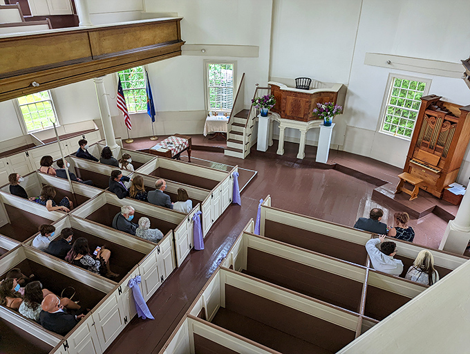 Sunlight streams through tall windows, illuminating the church's interior where generations have gathered for worship, meetings, and celebration.