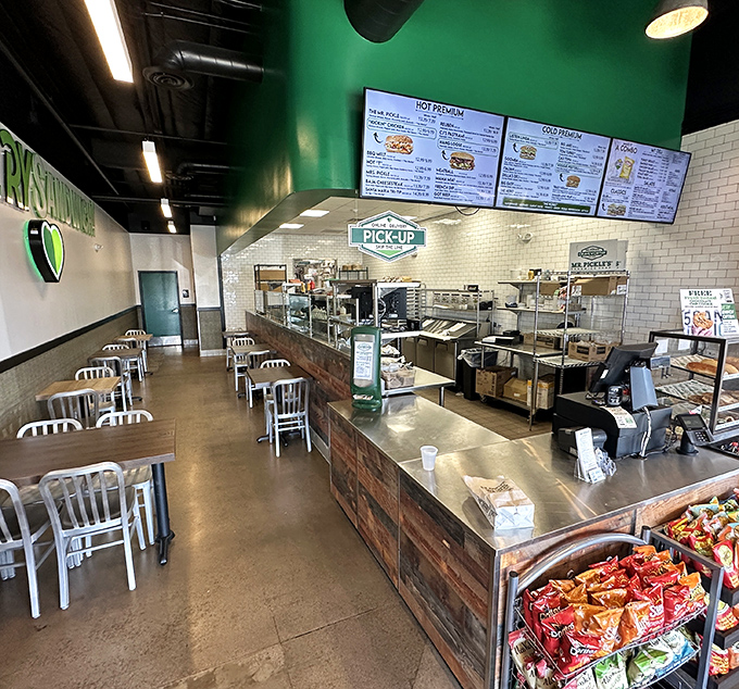 Clean lines, bright subway tiles, and that signature green create a space where sandwich artistry happens before your eyes.