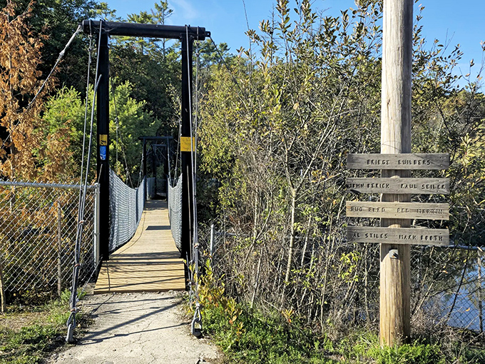 Nature's welcome sign: The trailhead bridge stands ready for explorers, with helpful markers pointing the way to Vermont's hidden gem.