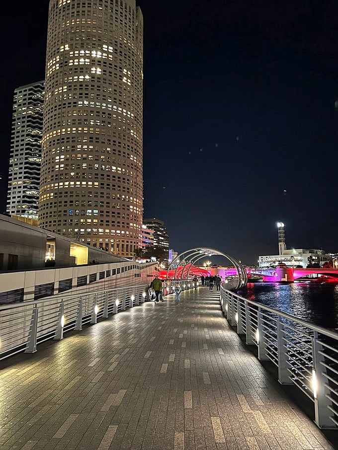 As night falls, the Riverwalk transforms into a magical light show, with illuminated pathways guiding evening strollers through downtown's glow.