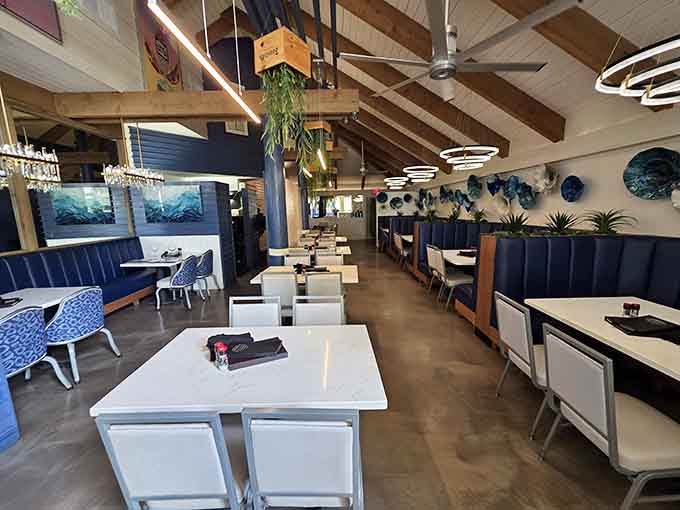 Exposed beams, stone walls, and blue booth seating create a vibe that's part rustic lodge, part tropical escape, all Florida charm.