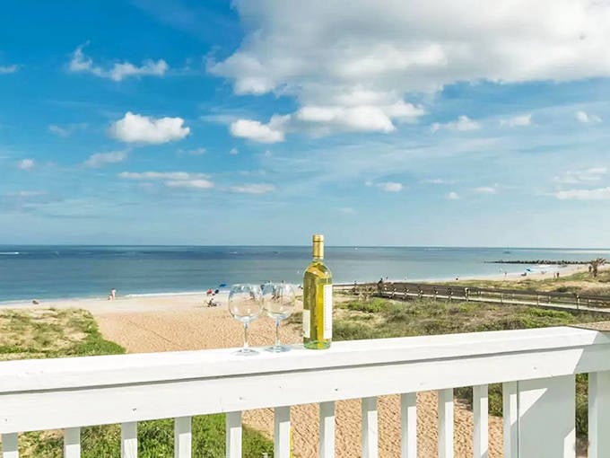 A perfect balcony view at Vilano Beach, where wine glasses await sunset viewers while gentle waves create a soothing soundtrack.