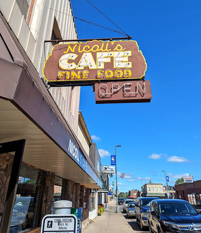 The classic neon "OPEN" sign glows against Mia's Cafe's stone facade. This Main Street fixture in Pine City promises honest small-town dining without big-city prices.