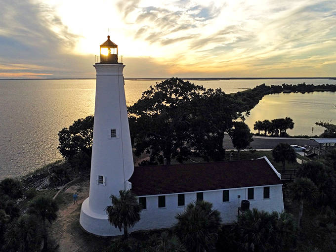 As sunset approaches, St. Marks Lighthouse casts a golden glow across the water. The silhouette of this historic beacon creates a magical moment for visitors.